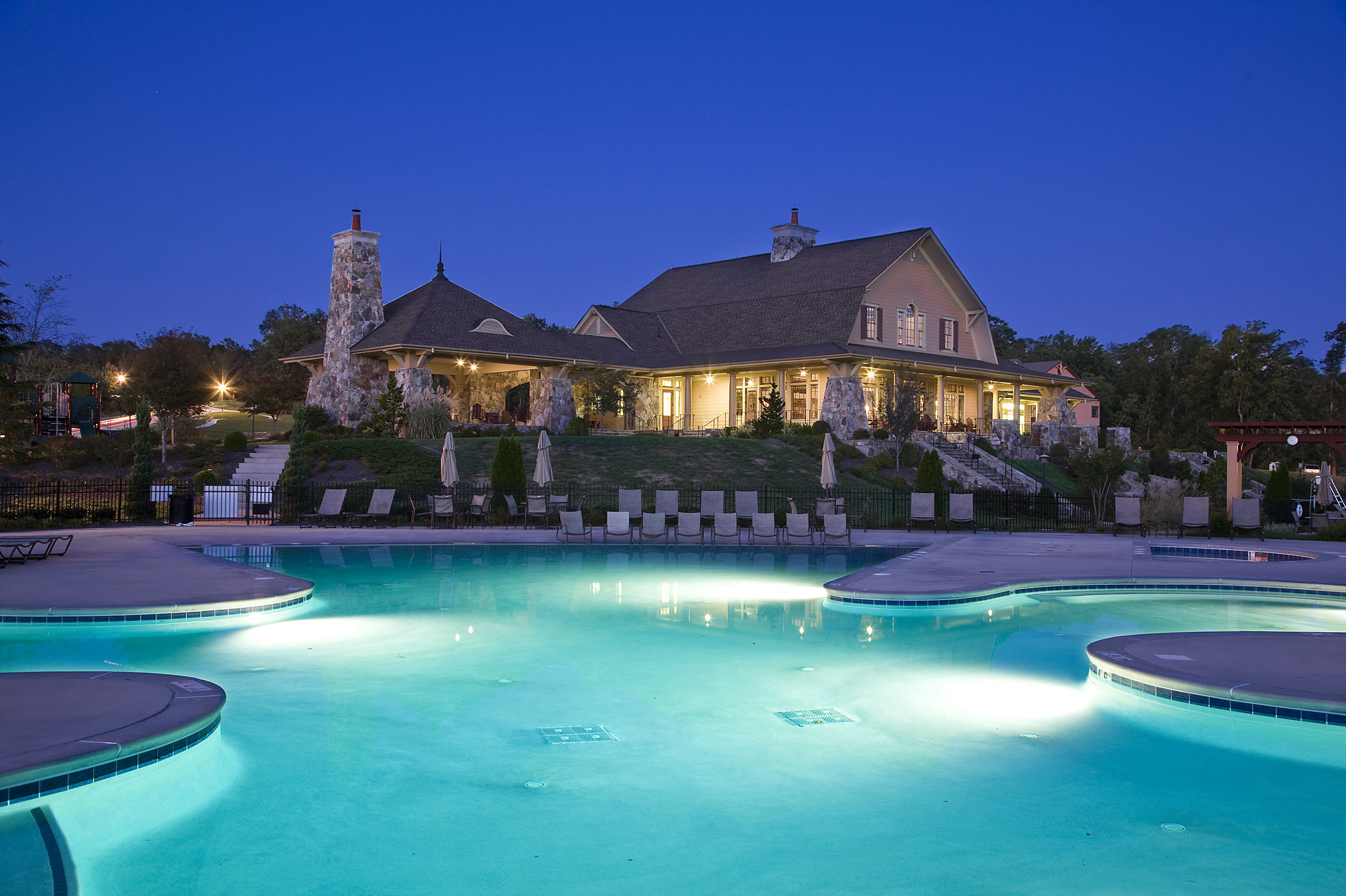 Pool w Clubhouse Night Angle - New Homes Division